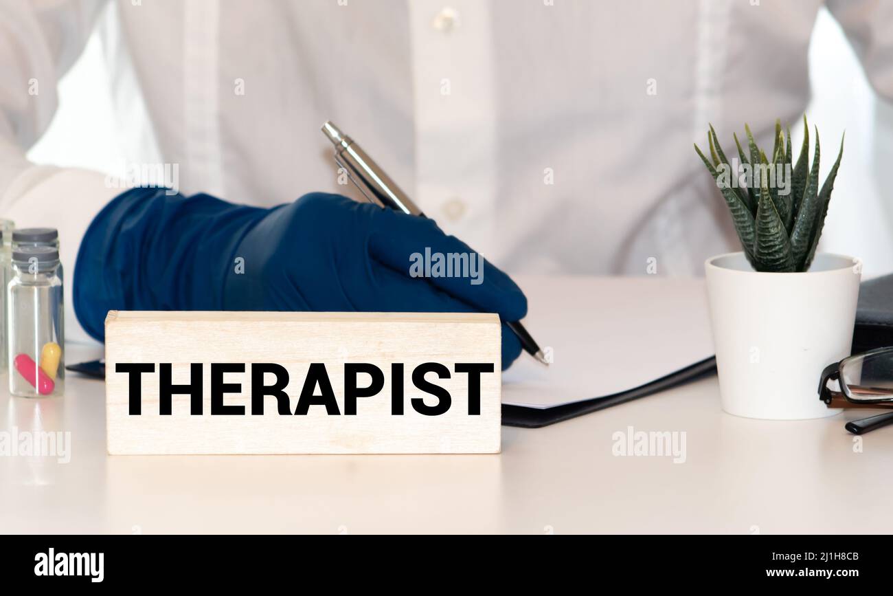 doctor writing word THERAPIST with marker. Medical concept Stock Photo ...