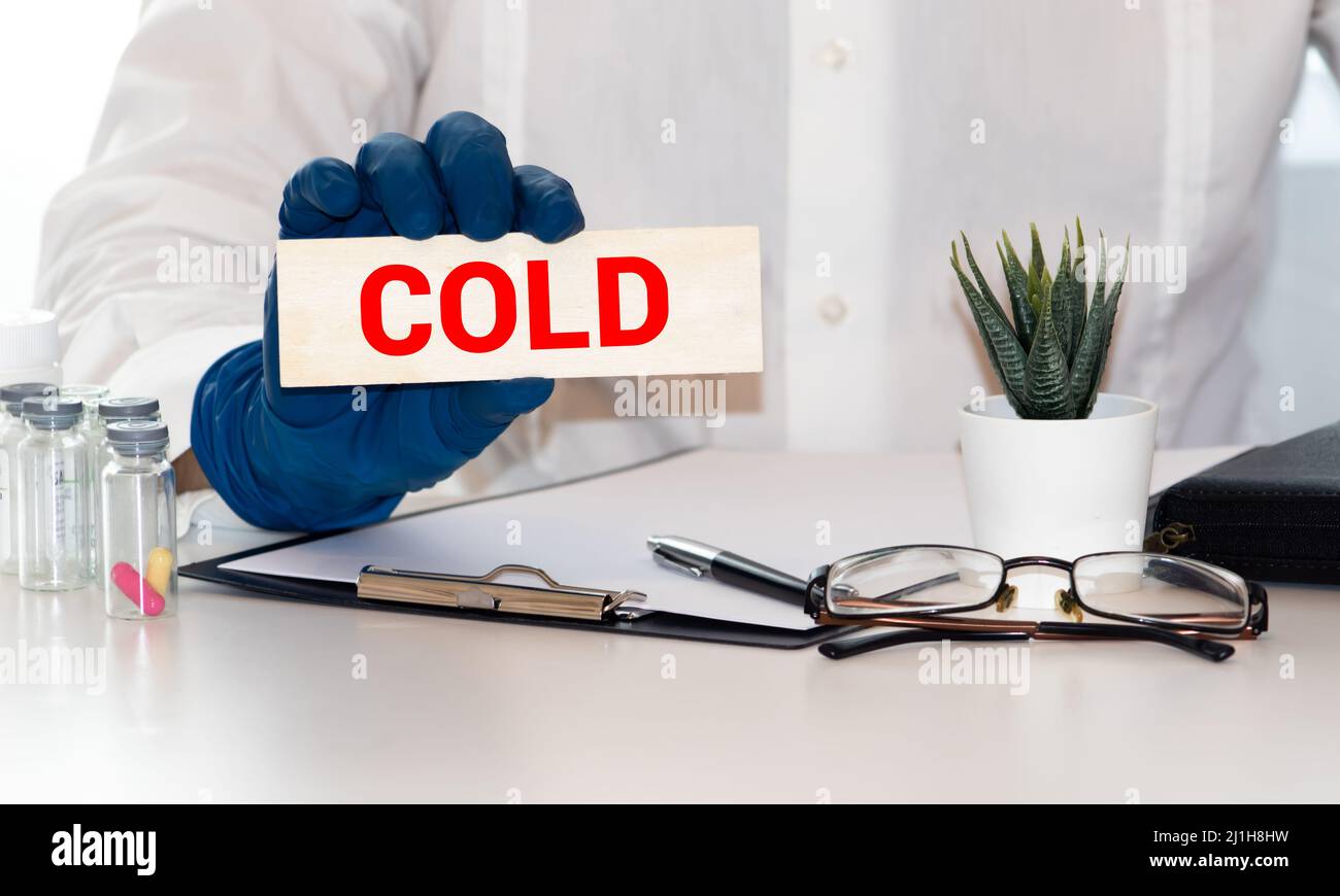 A Hand Holding Wooden Letters Spelling Out The Word Cold. Passing On A ...