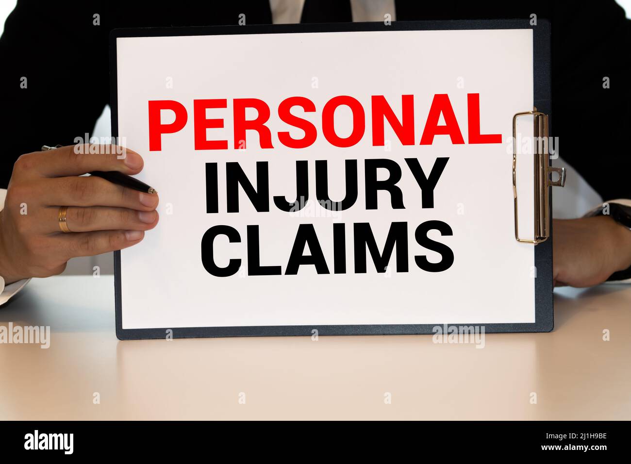 Personal injury claim written on color sticker notes over cork board ...