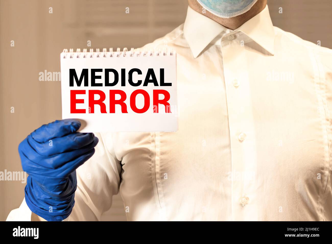 Doctor holding clipboard with medical error text on a sheet of paper on ...
