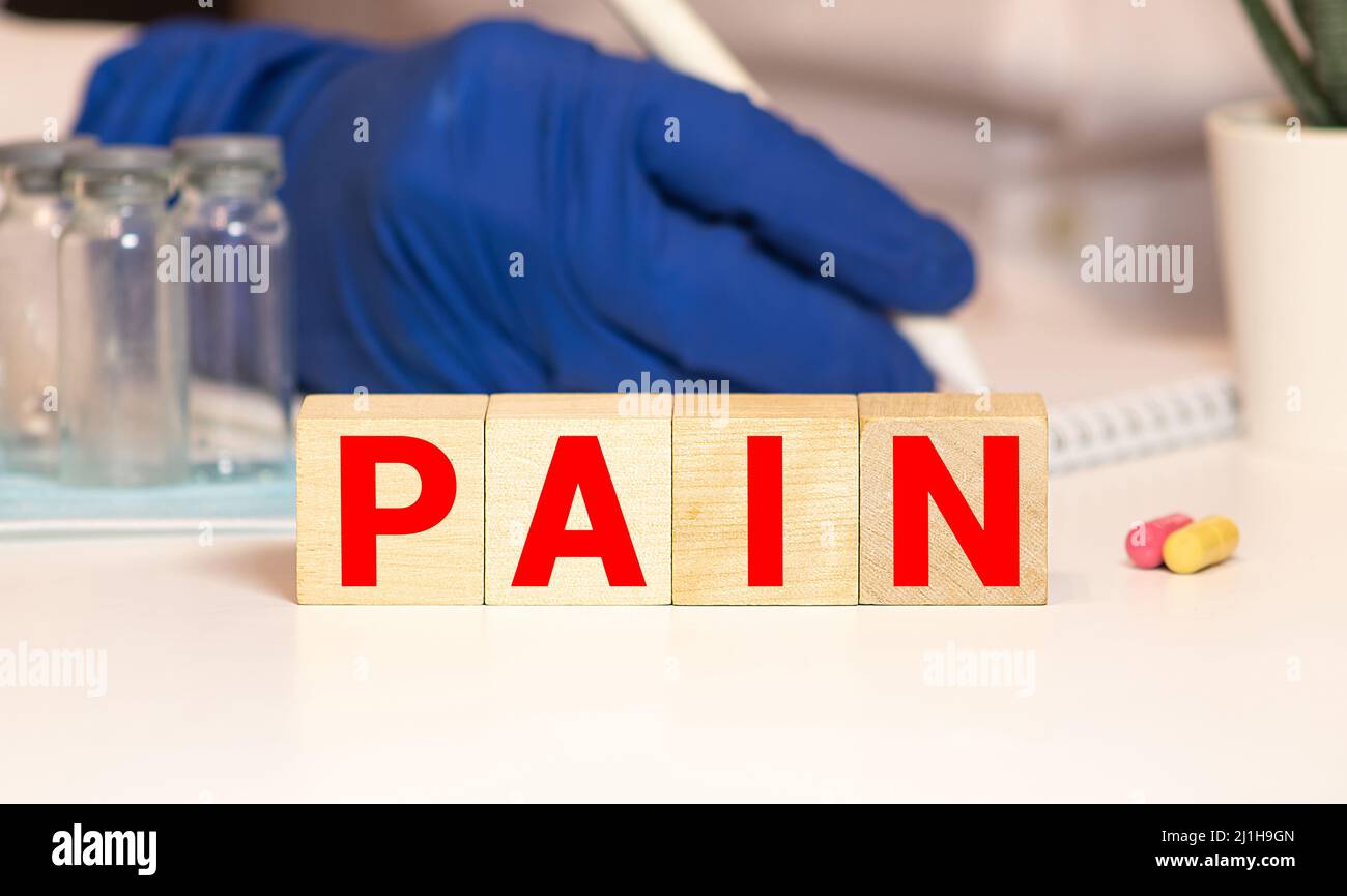 Pain word - in letterpress wood block on wooden background Stock Photo ...