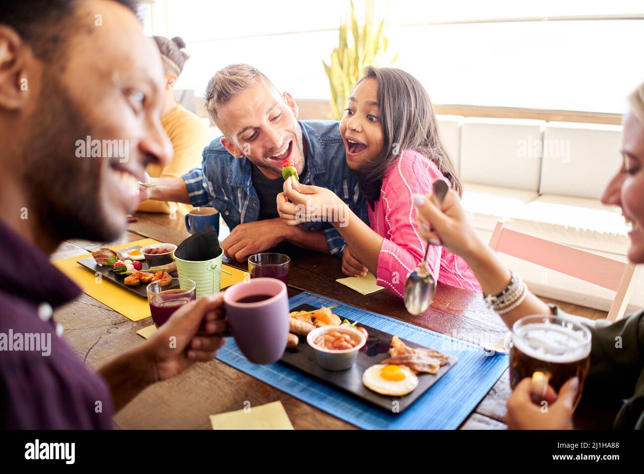 Group of friends having lunch at restaurant. Cheerful young people ...