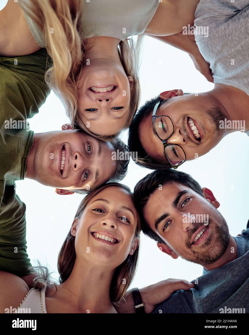 Putting our heads together. Low angle portrait of a young group of ...