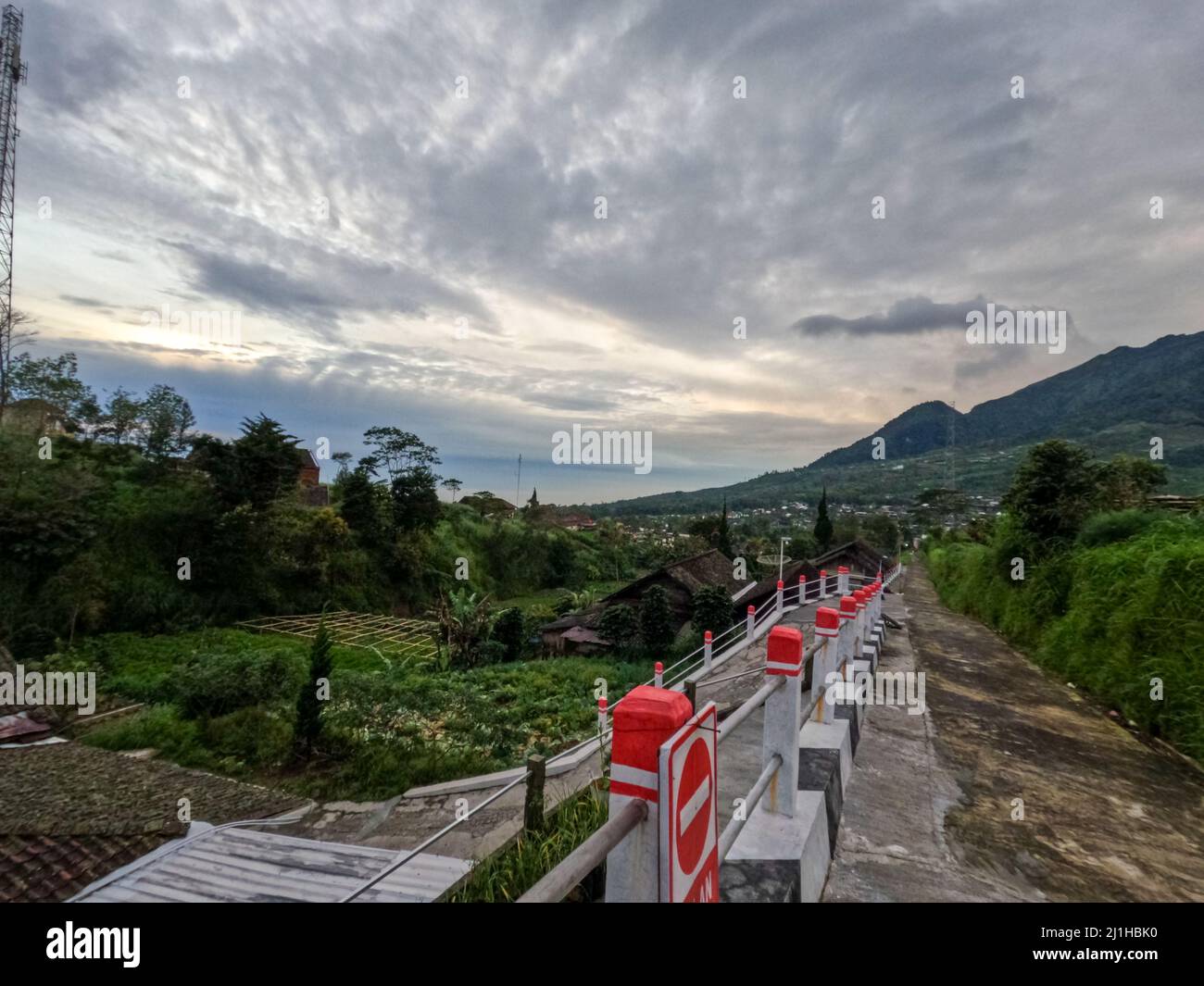 View of a narrow road in the countryside with green surroundings with ...
