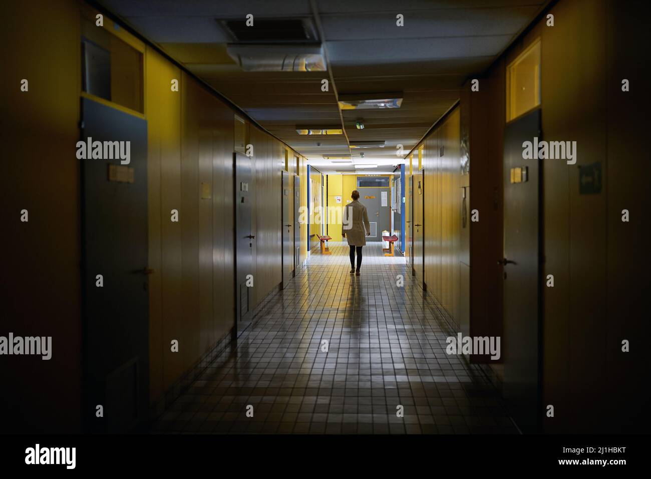 An institution employee walking a dark and spooky hallway. Institution ...