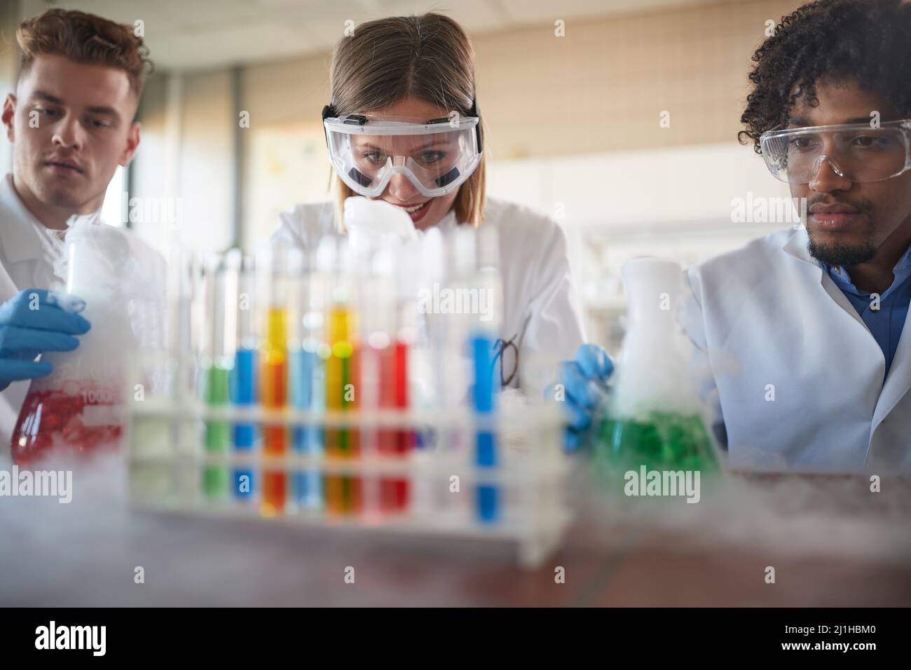 Young chemistry students in a laboratory relaxed atmosphere doing an ...