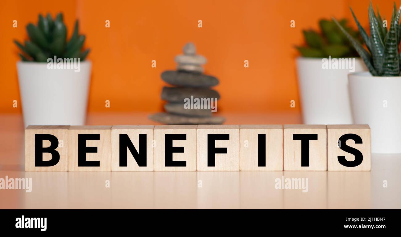 BENEFITS word written on wood block. BENEFITS text on wooden table for ...