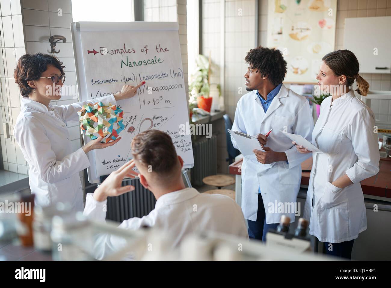Young chemical students have a lecture in a relaxed atmosphere in the ...