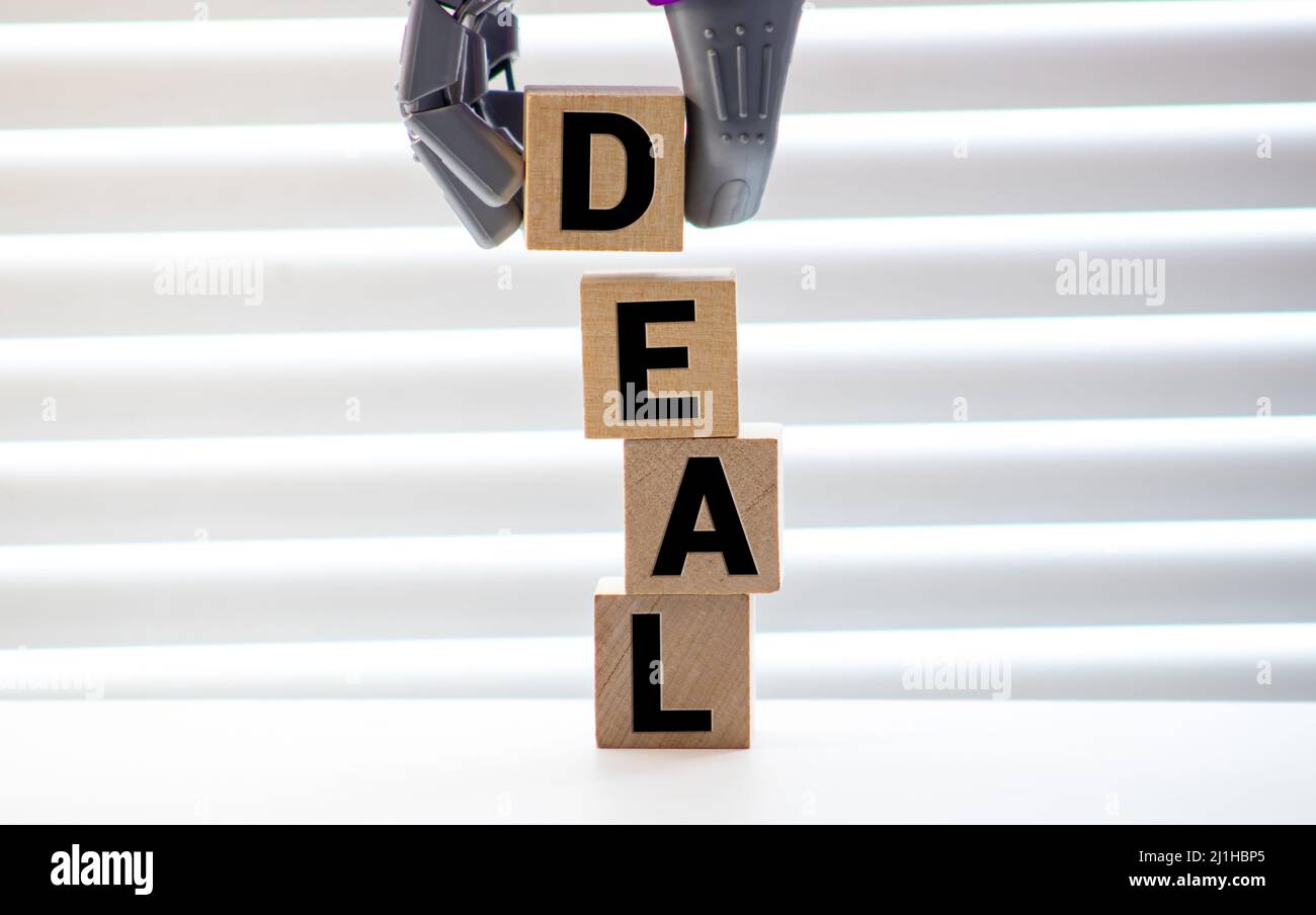 DEAL word on cube blocks on blue background Stock Photo - Alamy