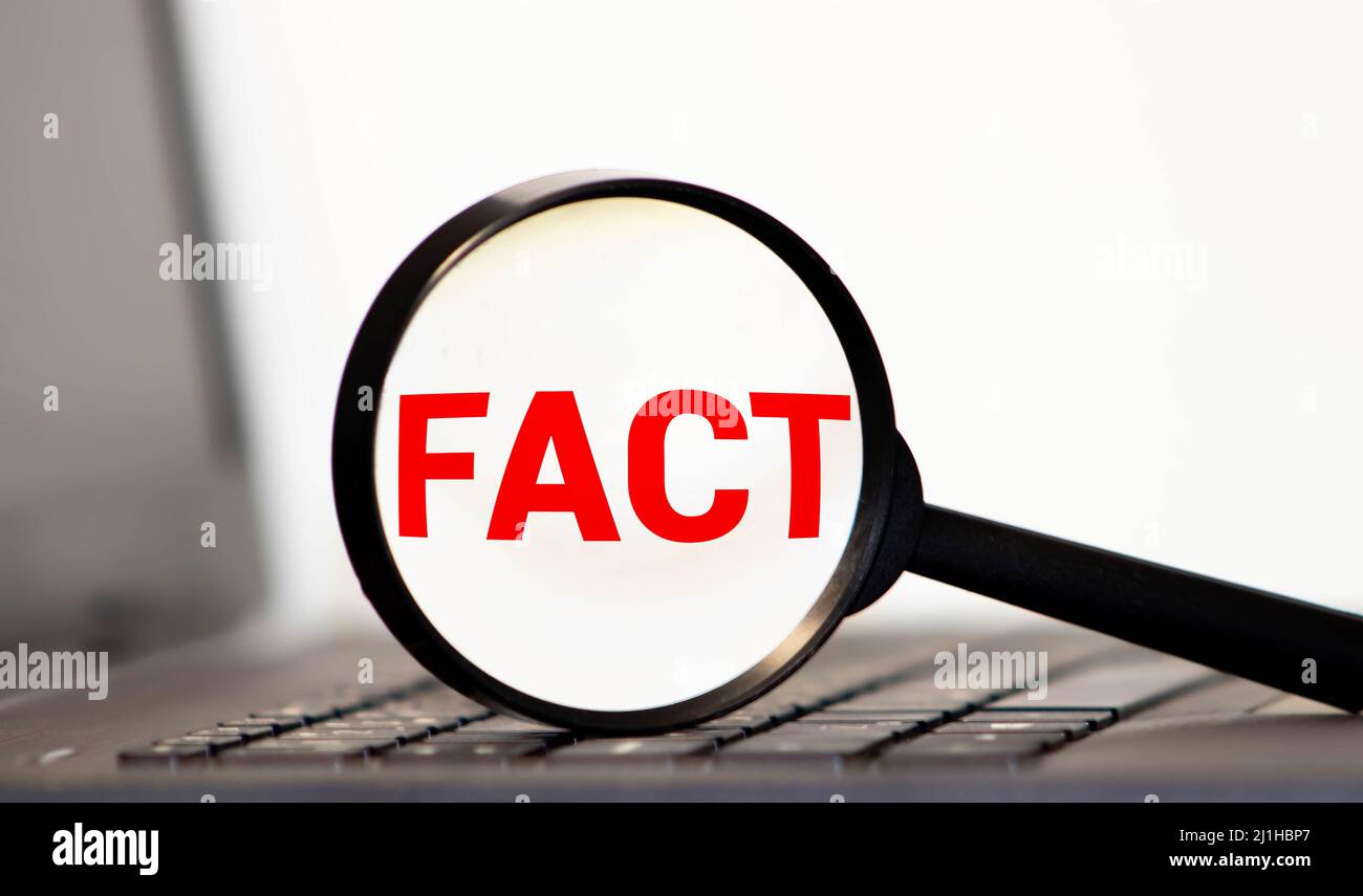Hand Showing Facts Word Through Magnifying Glass Stock Photo - Alamy