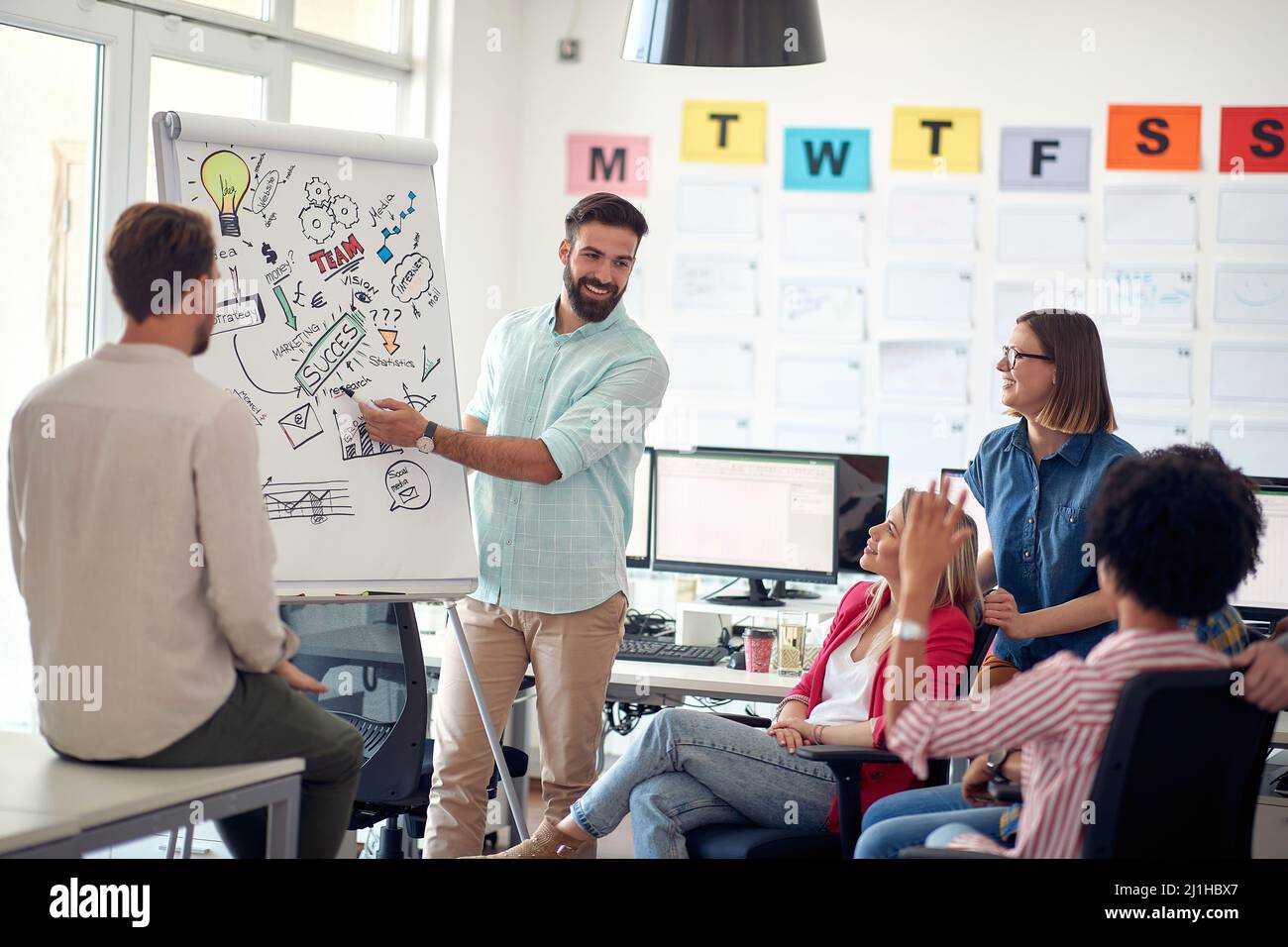 Group of multiethnic ambitious employees brainstorming together in the ...