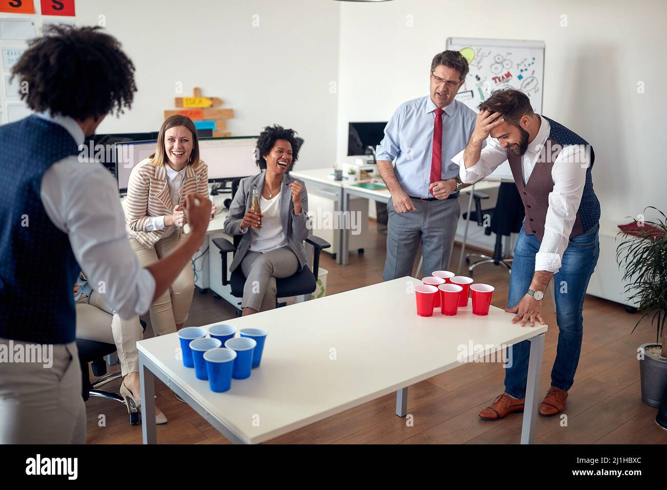 Group of diverse casual corporate coworkers having fun in the office ...