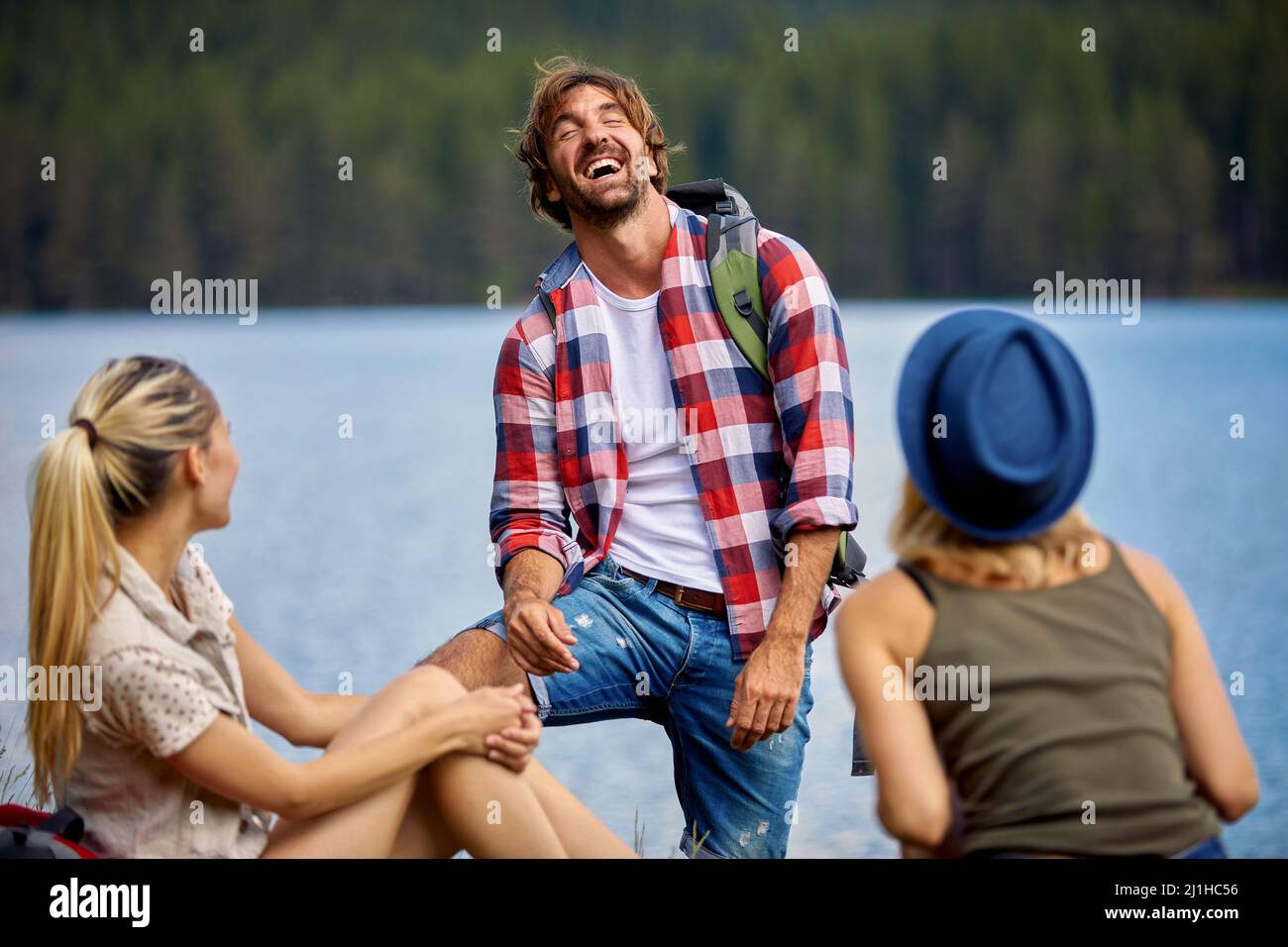 Friends enjoying time in nature. Young people on hike, laughing and ...