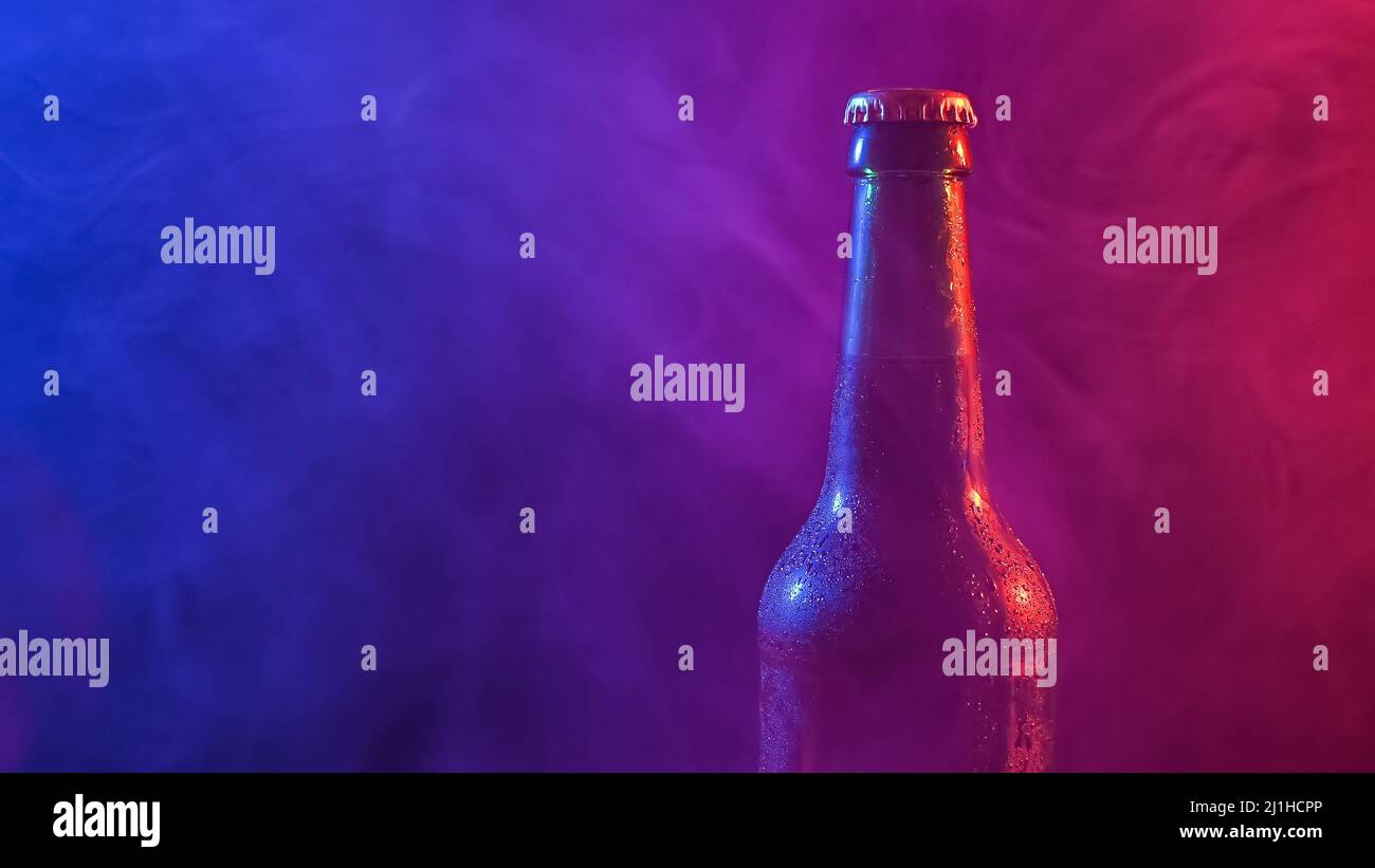 Glass bottle of beer in blue pink mist Stock Photo - Alamy