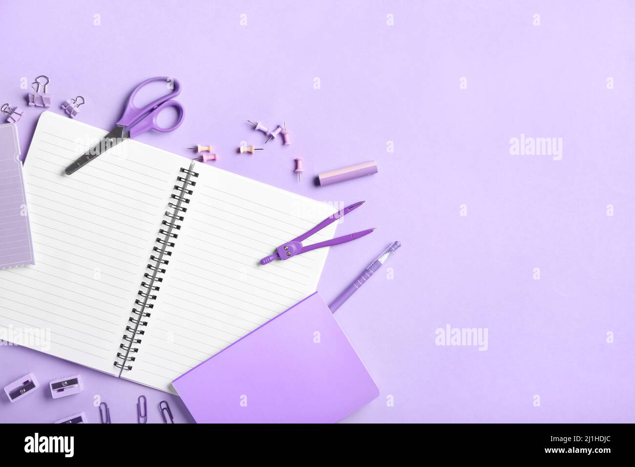Blank notebook and stationery on purple background Stock Photo - Alamy