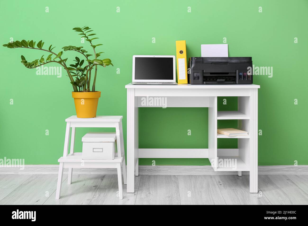 Workplace with modern laptop, printer and stepladder stool with ...
