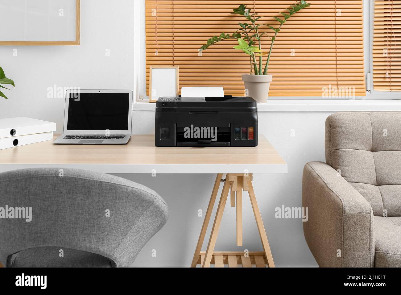 Workplace with laptop and printer in office Stock Photo - Alamy