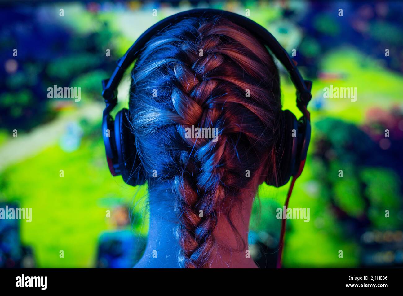 A girl is a gamer or a streamer in front of a television playing.It is ...