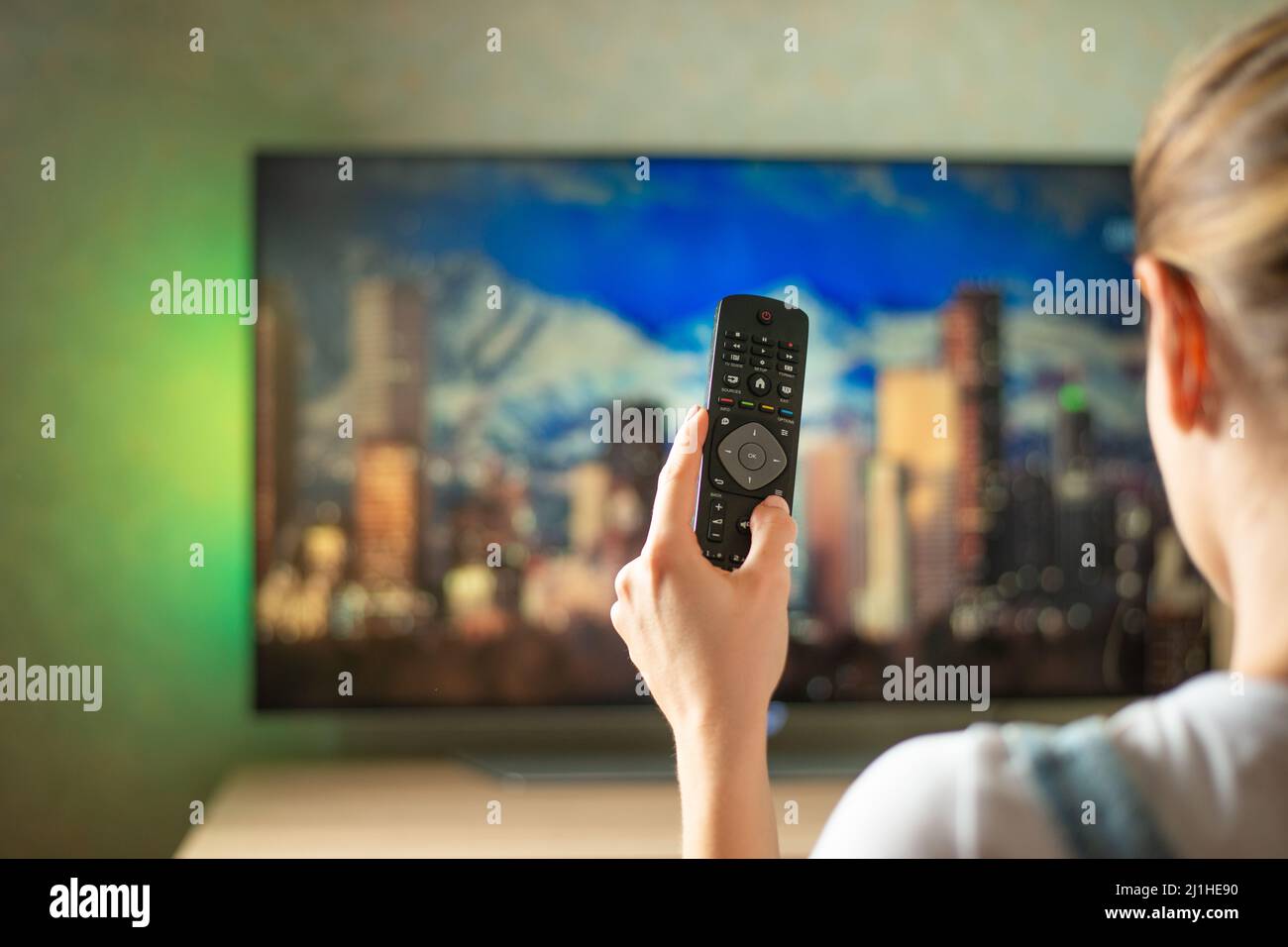 Girl with remote control includes TV, film, movie, view Stock Photo - Alamy
