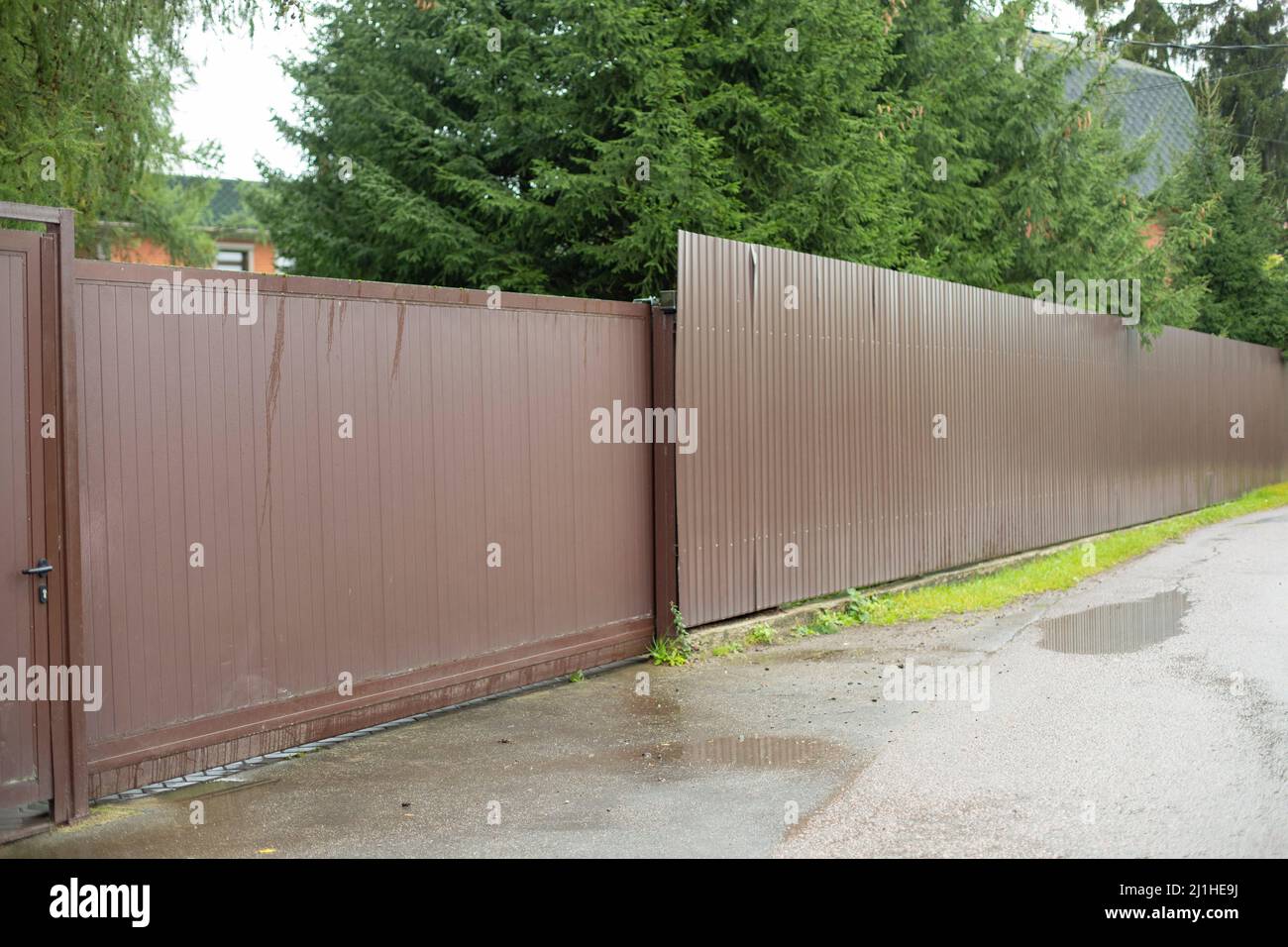 Gates and fence. Sliding gates for entrance to site. Fence around house ...