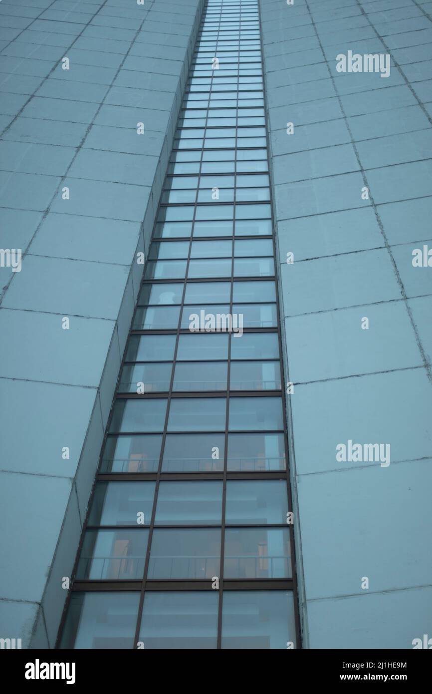 High-rise building on gray day. Architecture details. Surface of wall ...