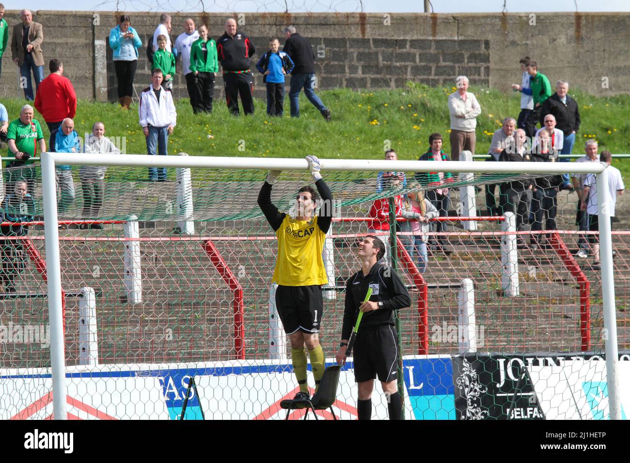 23 APRIL 2011 Glentoran goalkeeper Elliott Morris fixes the goal net ...
