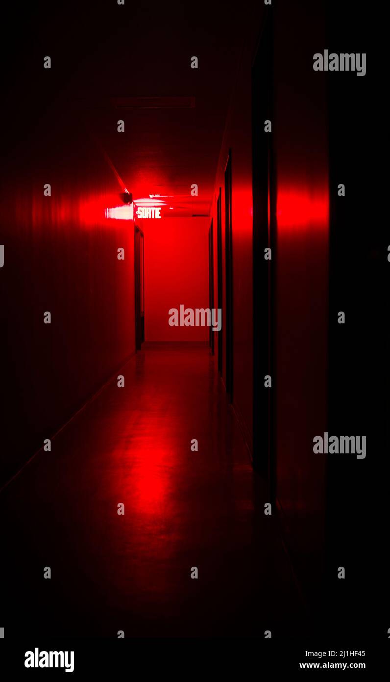 Creepy red-lit corridor in an old hospital Stock Photo - Alamy