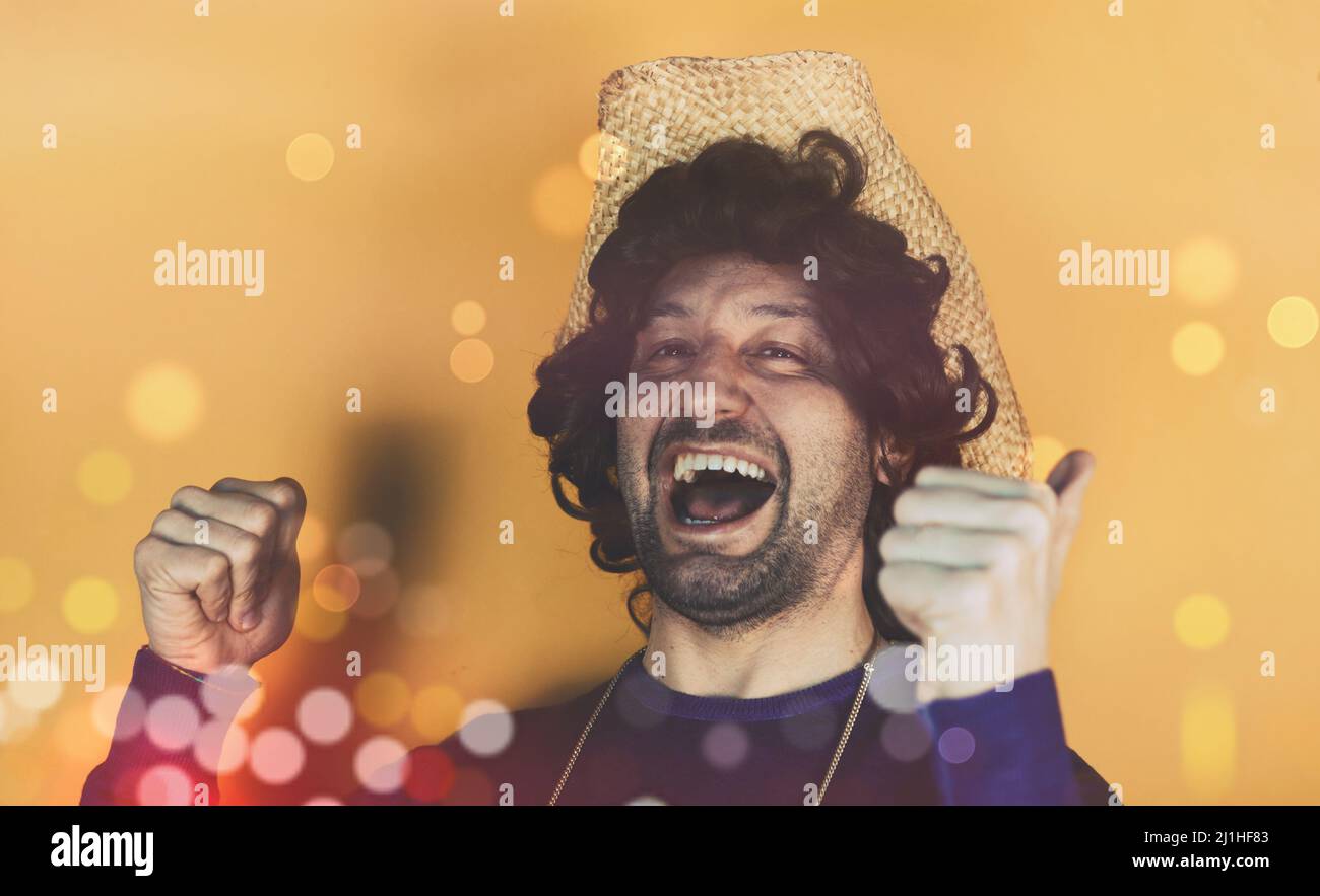 Portrait of an amused excited man in a purple shirt standing and ...