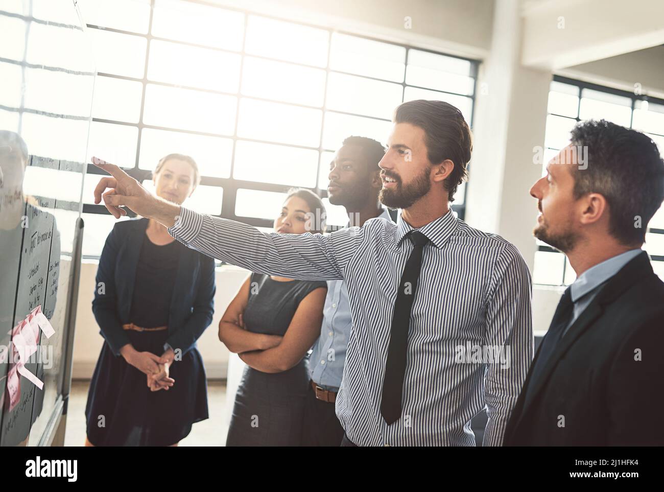 Any more ideas about this. Shot of a group of businesspeople looking ...