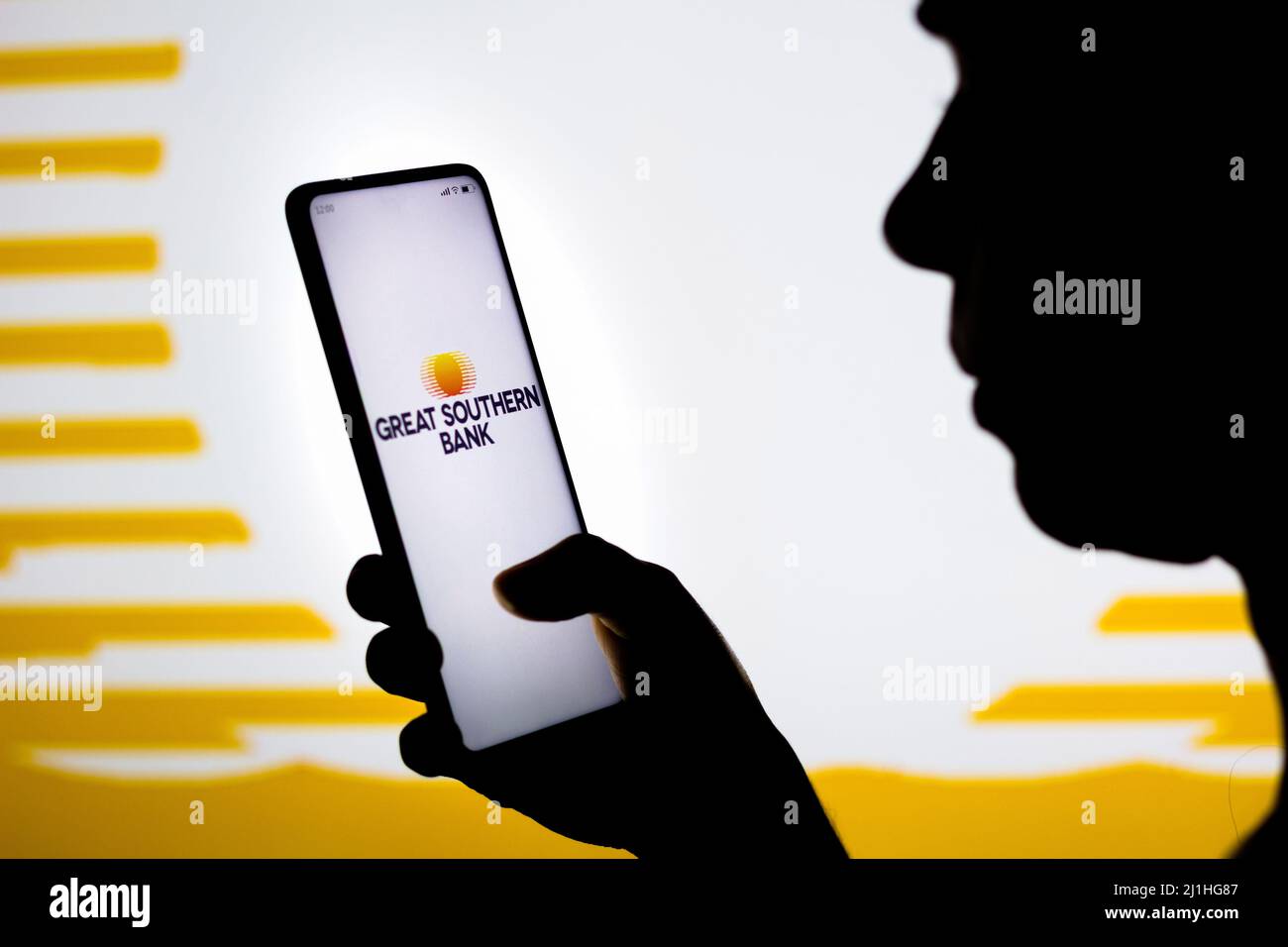 In this photo illustration, a woman's silhouette holds a smartphone ...