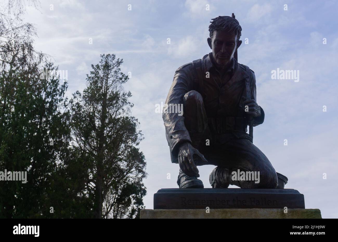 Soldier reaching down with short hair and rifle held over shoulder ... Soldier reaching down with short hair and rifle held over shoulder ...