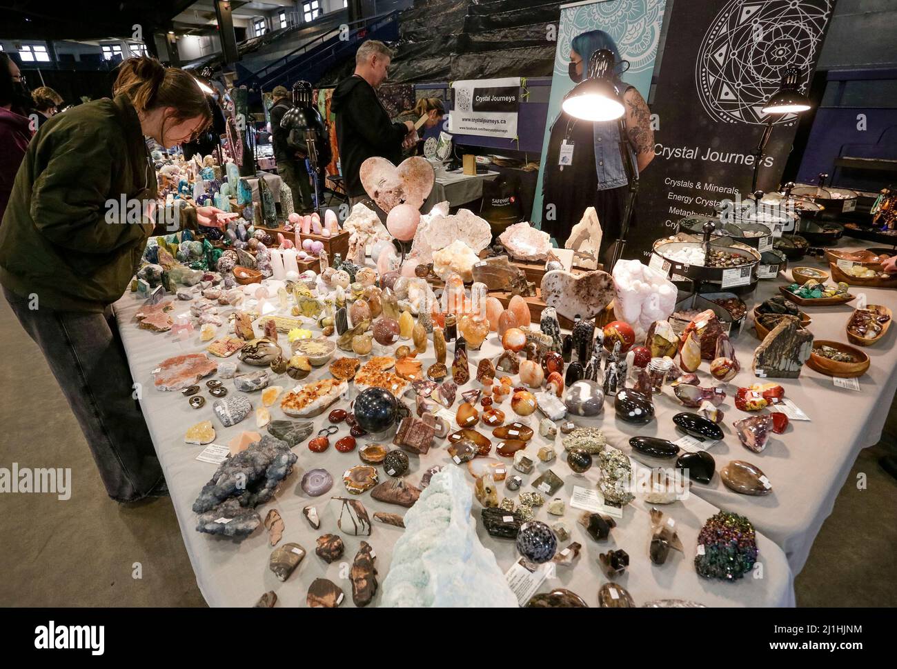 Vancouver, Canada. 25th Mar, 2022. People look at gemstones displayed ...