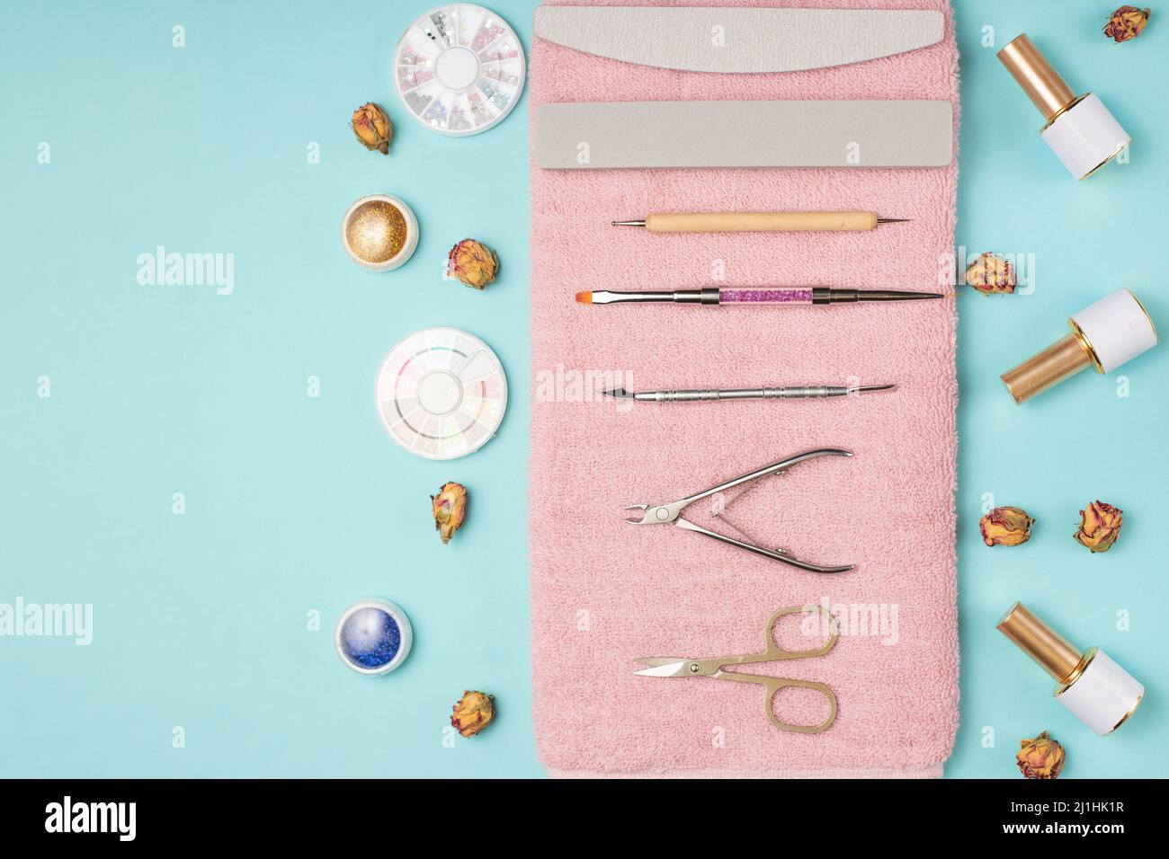A set of cosmetic tools for manicure and pedicure on a blue background ...