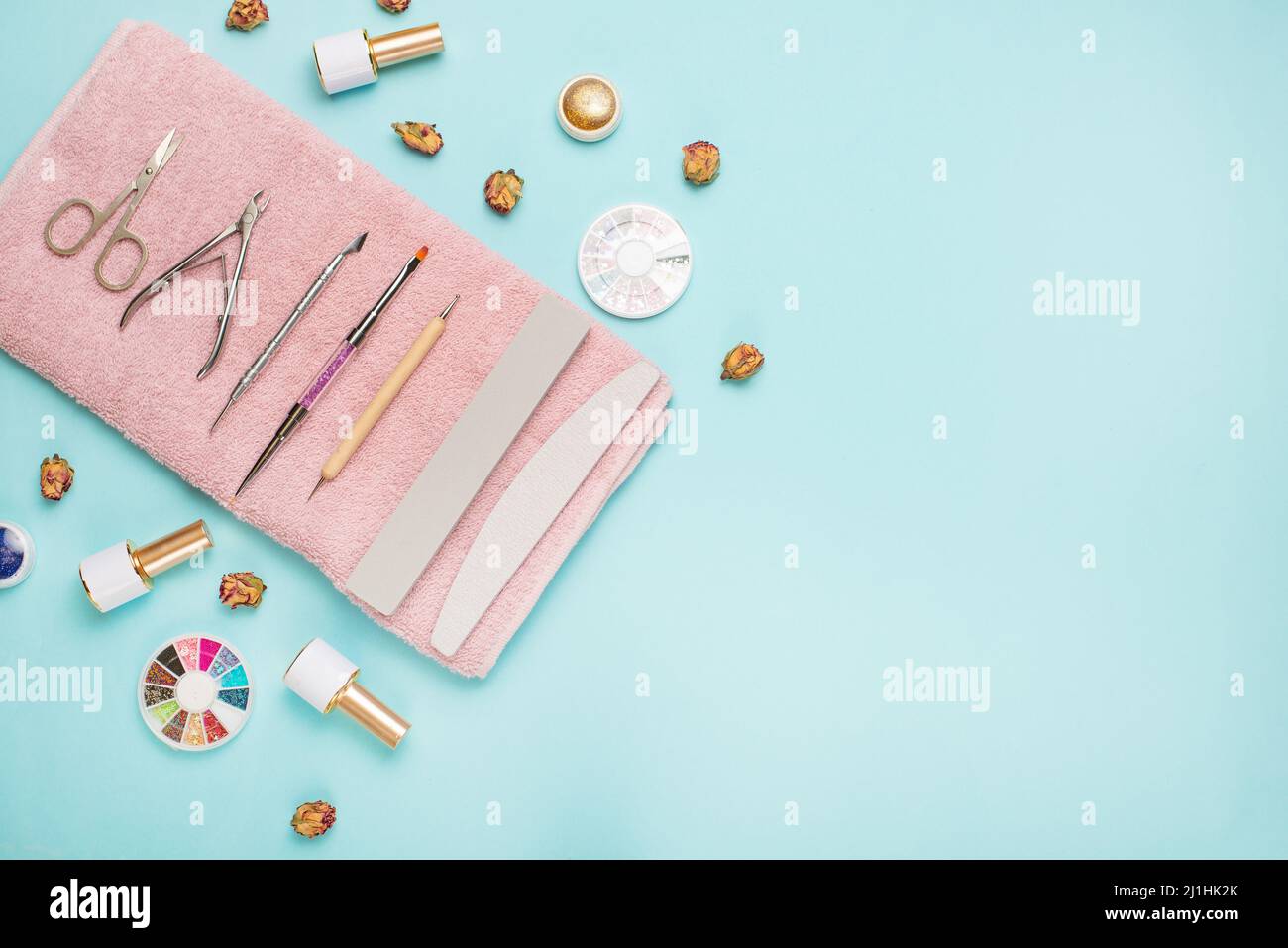A set of cosmetic tools for manicure and pedicure on a blue background ...