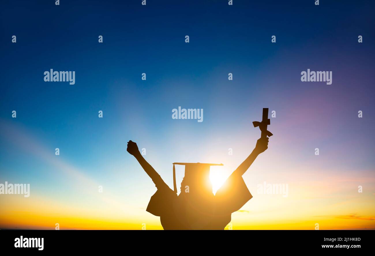 The silhouette of Student Celebrating Graduation watching the sunlight ...