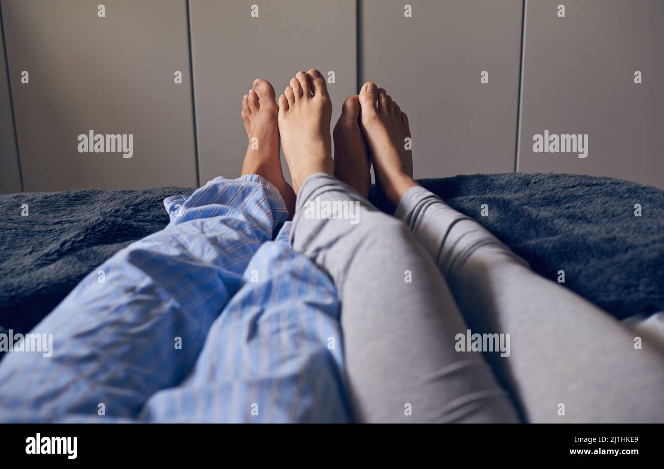 Finding comfort in each other. Cropped shot of a couple lying down ...