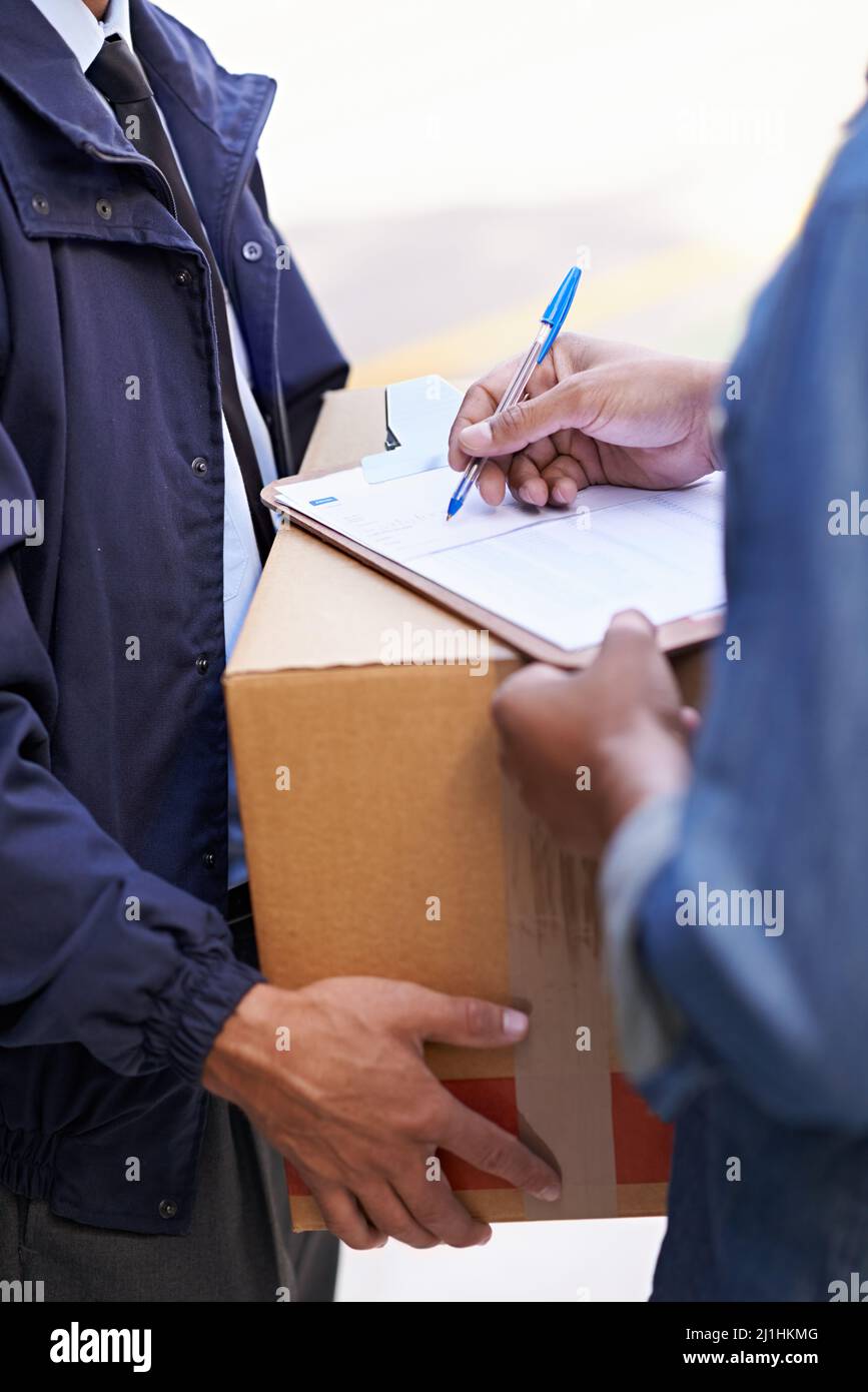 Delivering direct to your door. A friendly delivery man delivering a ...