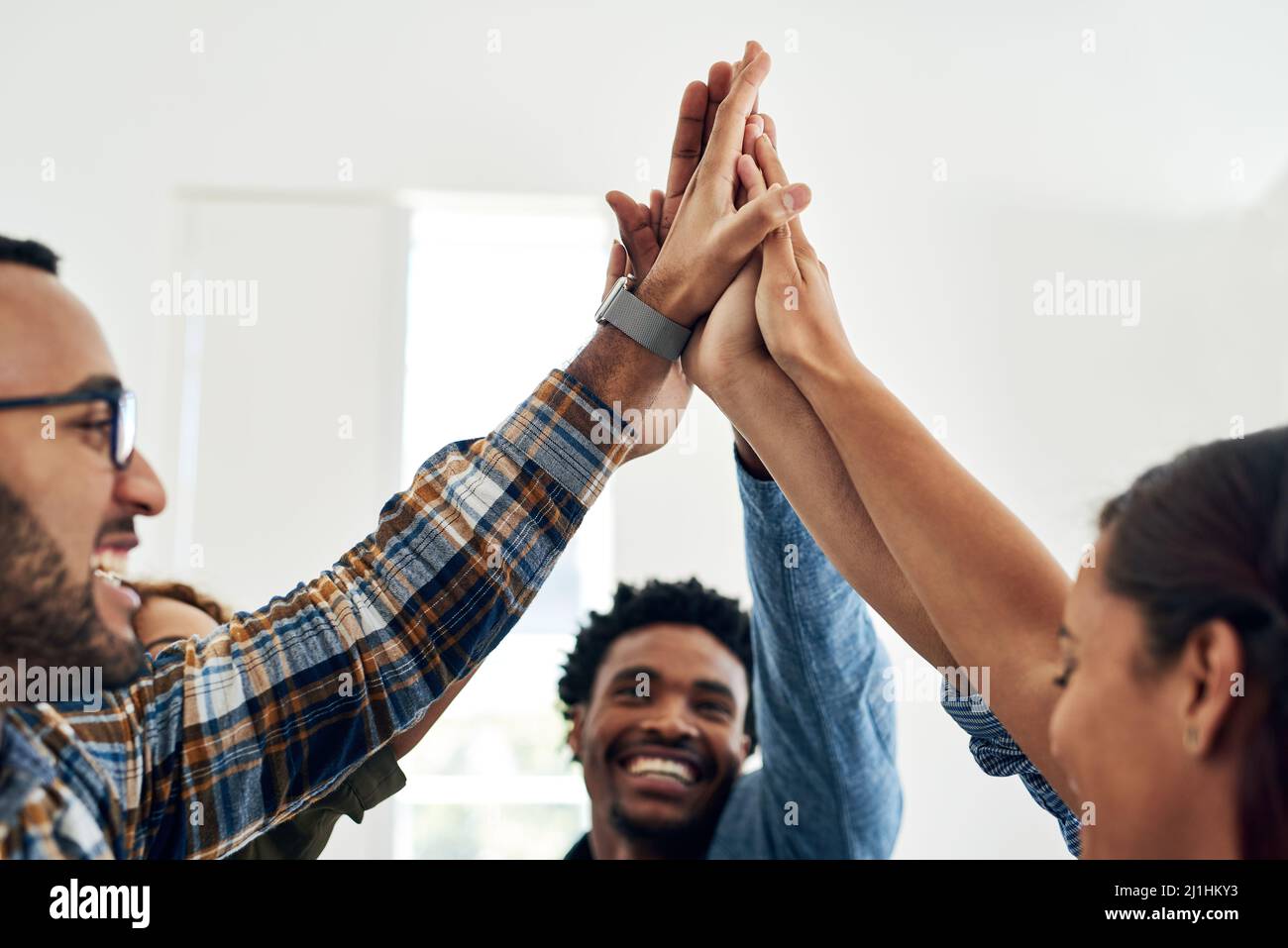 Teamwork for the win. Shot of a group of colleagues giving each other a ...