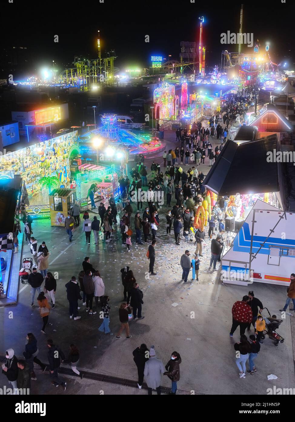 Aerial photo of a crowded night fair illuminated by colorful neon ...