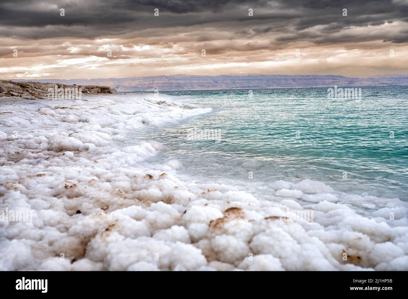 Salt beach of the Dead Sea at sunset, Jordan Stock Photo - Alamy