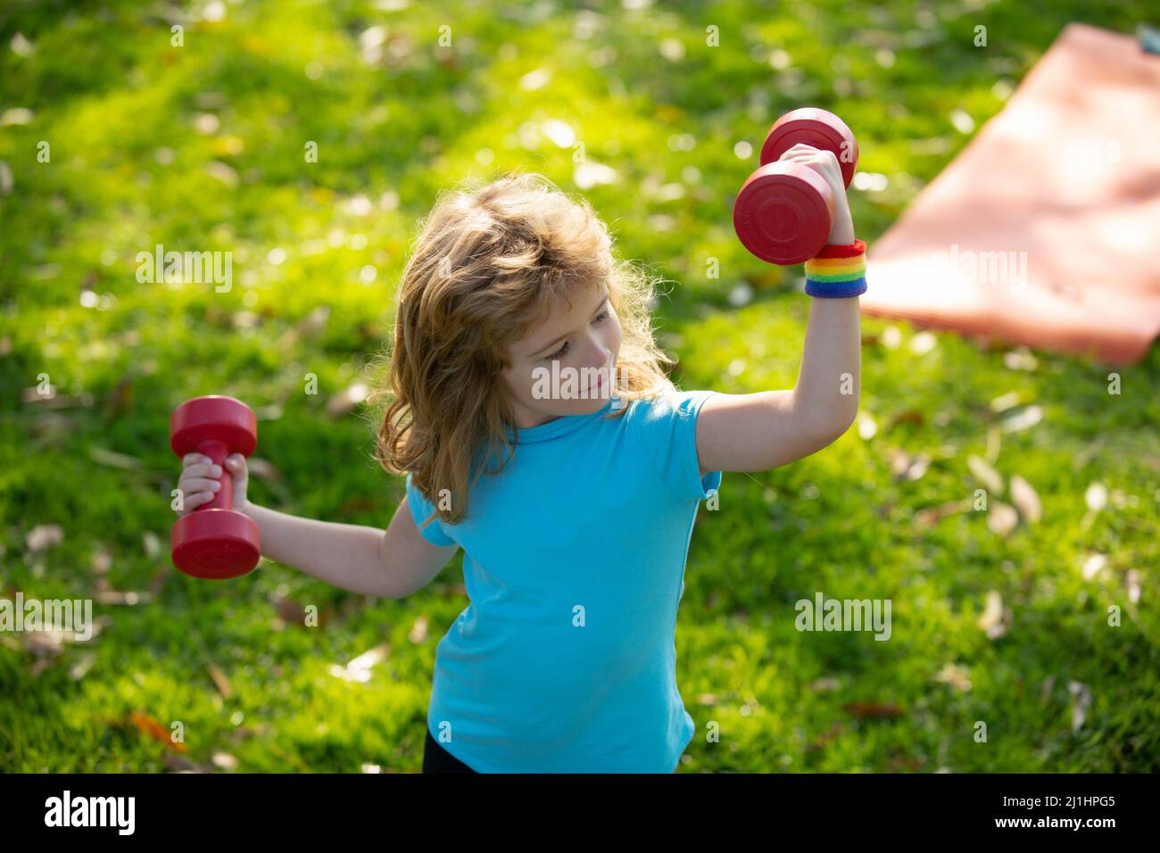 Boy is doing exercises to develop muscles. Child is doing exercises ...