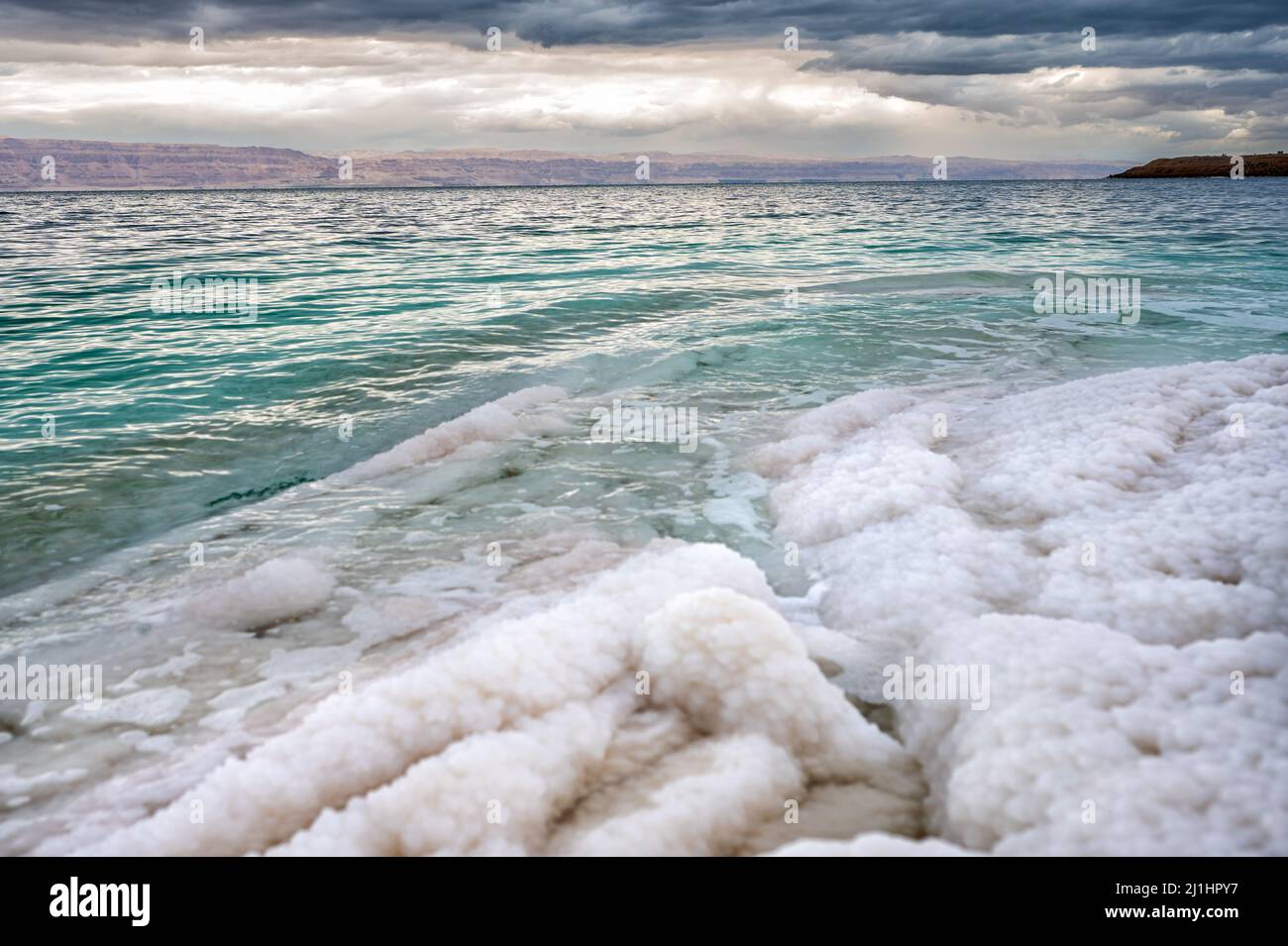 Salt beach of the Dead Sea at sunset, Jordan Stock Photo - Alamy