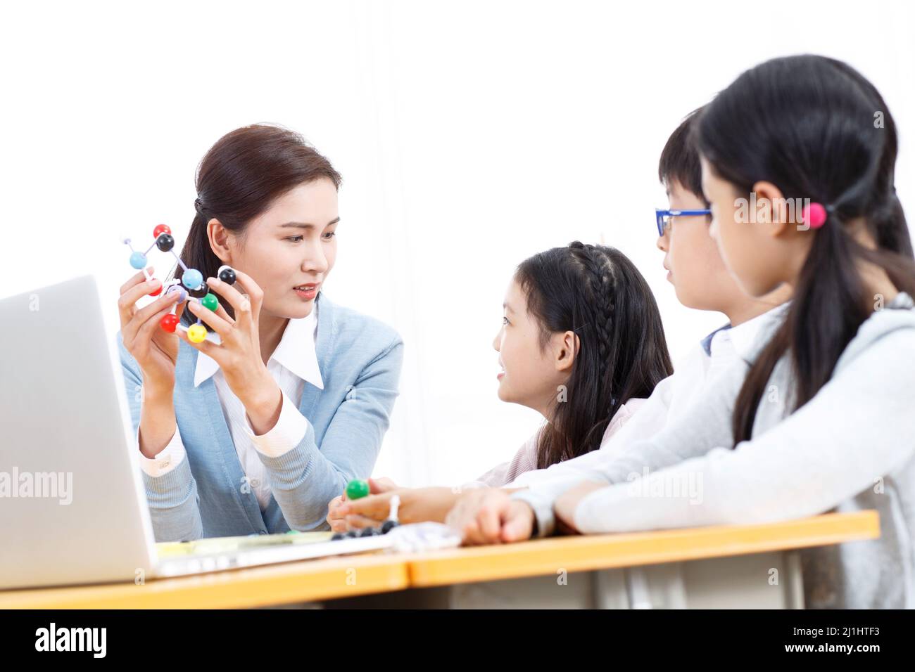 Female teachers and pupils to use the computer Stock Photo - Alamy