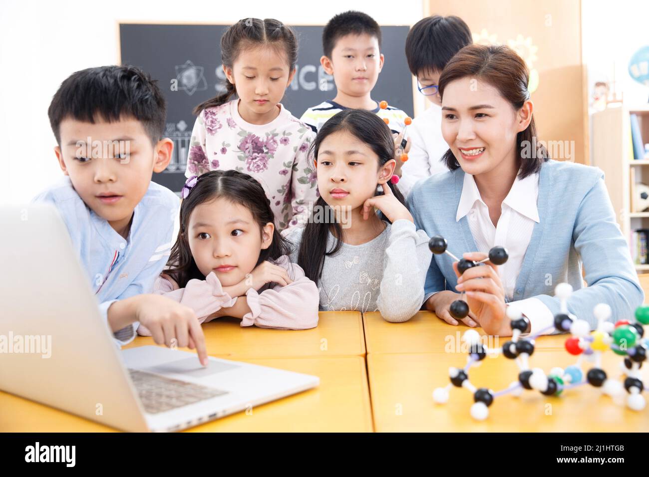 Female teachers and students use computers in the classroom Stock Photo ...