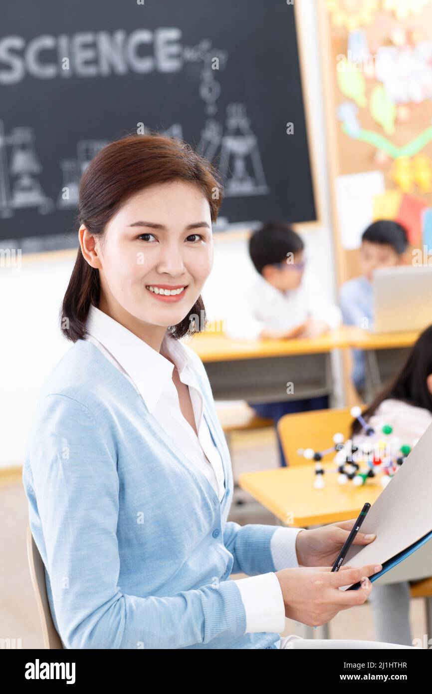 Female teachers and the pupils in the classroom Stock Photo - Alamy