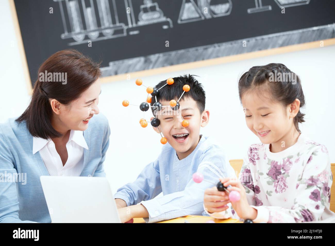 Female teachers and students use computers in the classroom Stock Photo ...