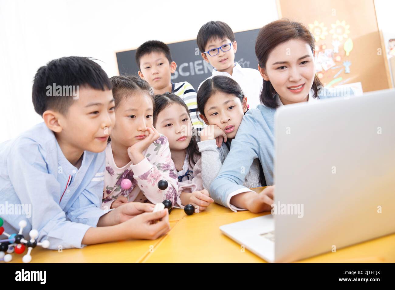 Female teachers and students use computers in the classroom Stock Photo ...