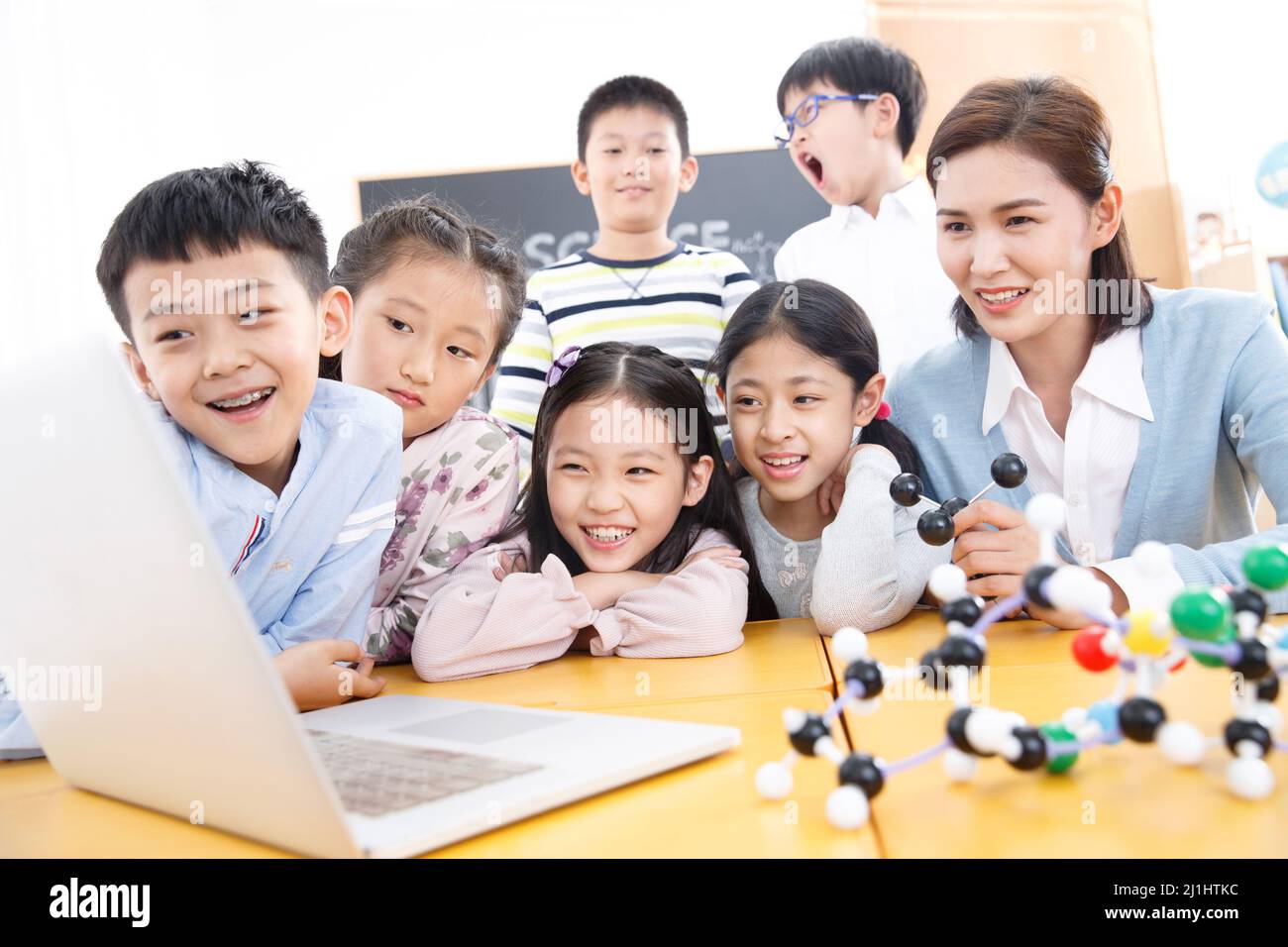 Female teachers and students use computers in the classroom Stock Photo ...