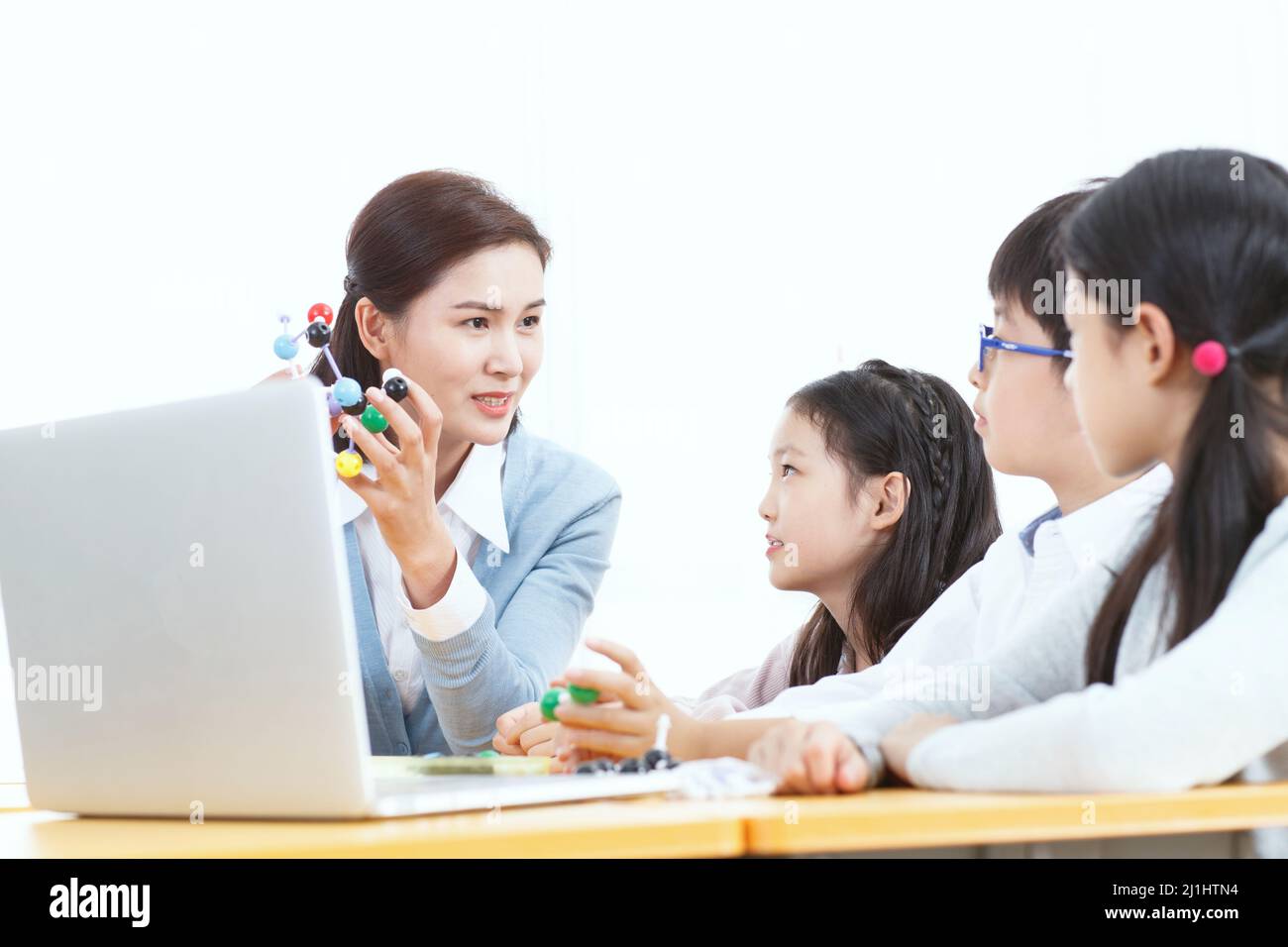 Female teachers and pupils to use the computer Stock Photo - Alamy