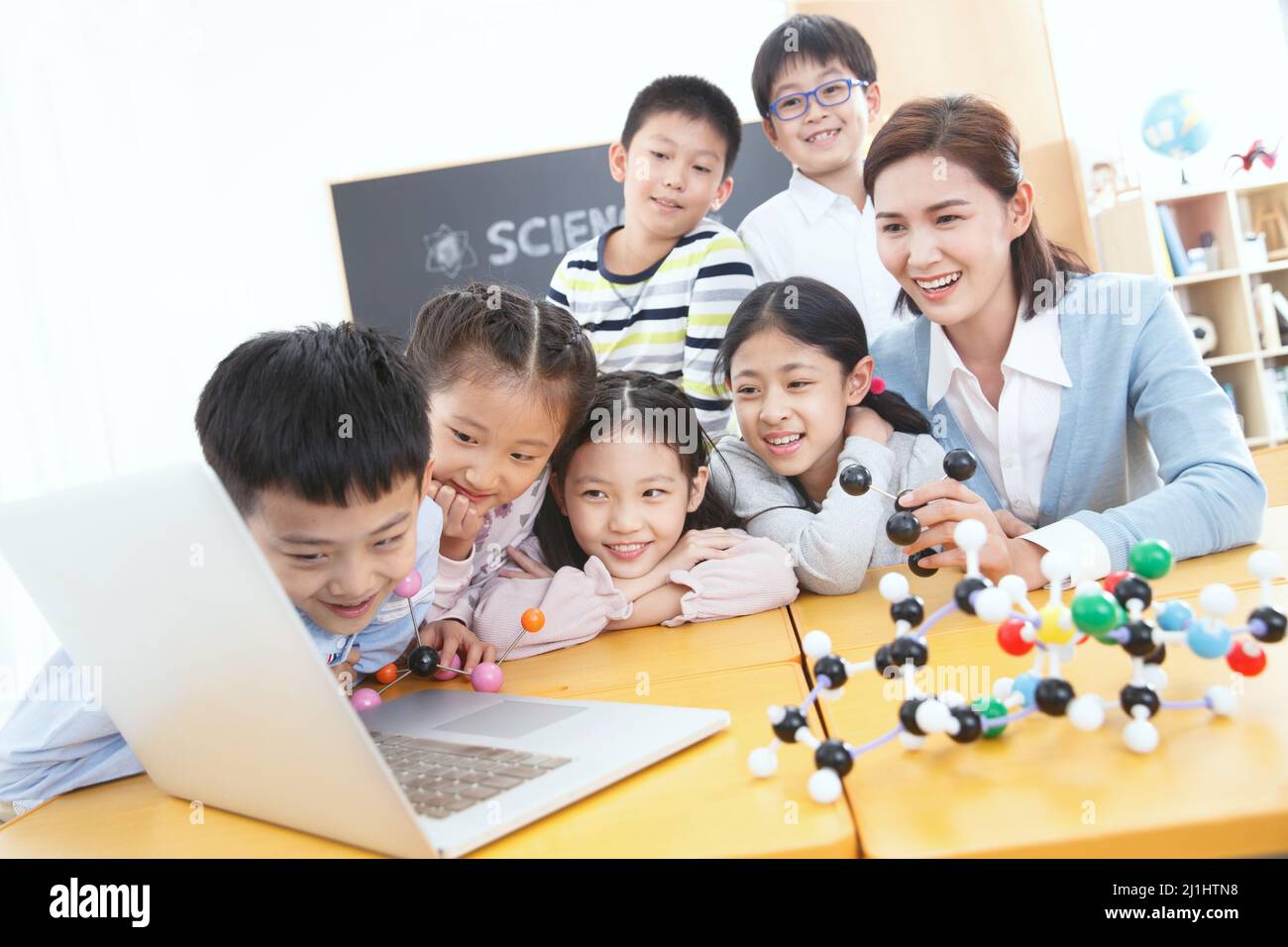 Female teachers and students use computers in the classroom Stock Photo ...